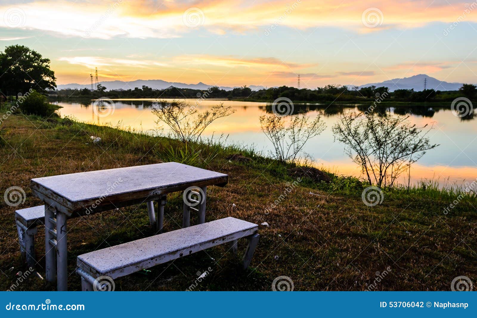 Table seats at lakeside stock photo. Image of evening - 53706042