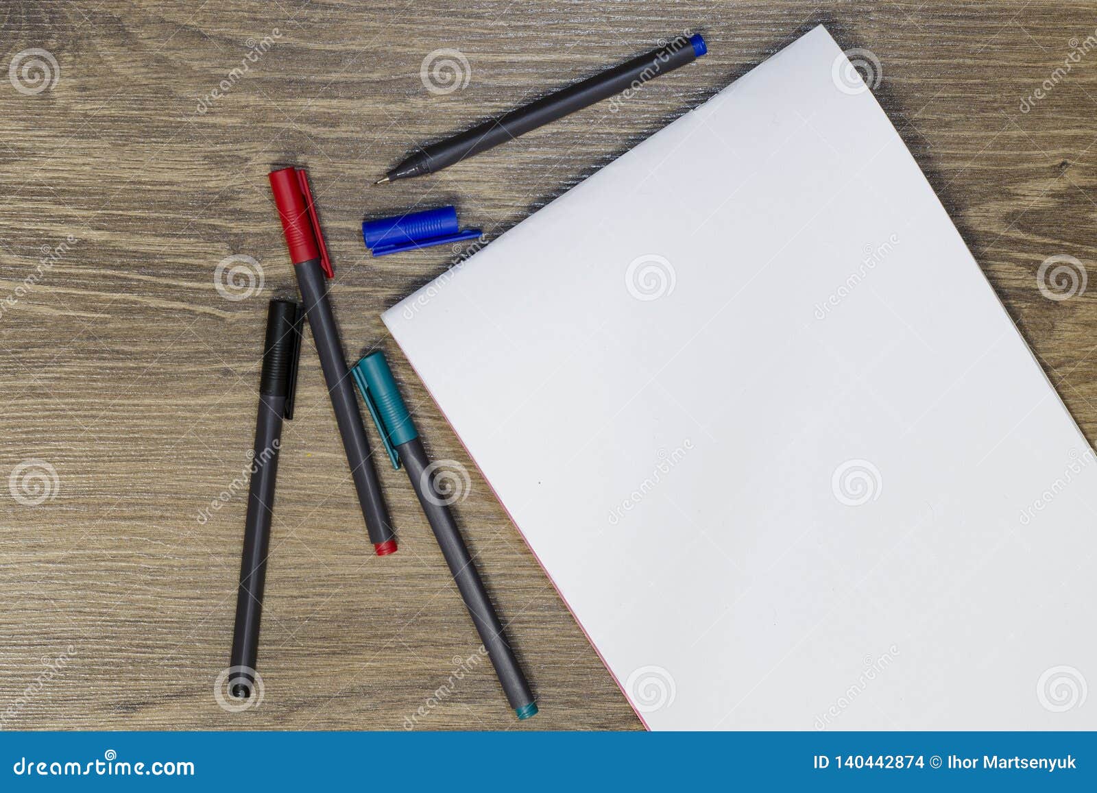 On the Table is a Set for Drawing: Four Markers and a White Sheet of ...