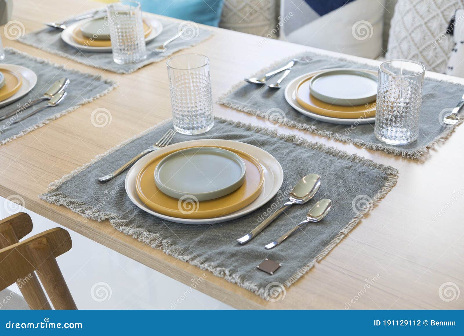 Table Set on Table with Yellow Plate Setting in Modern Style Dining ...