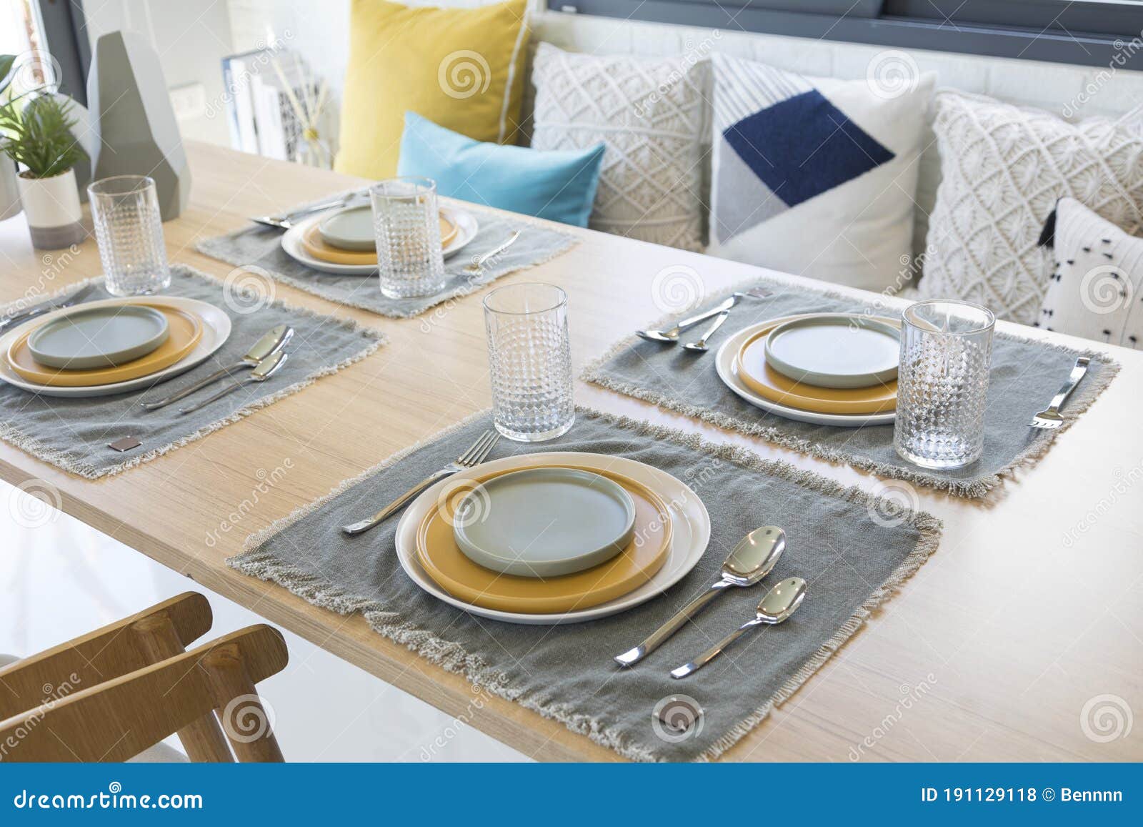 Table Set on Table with Yellow Plate Setting in Modern Style Dining ...