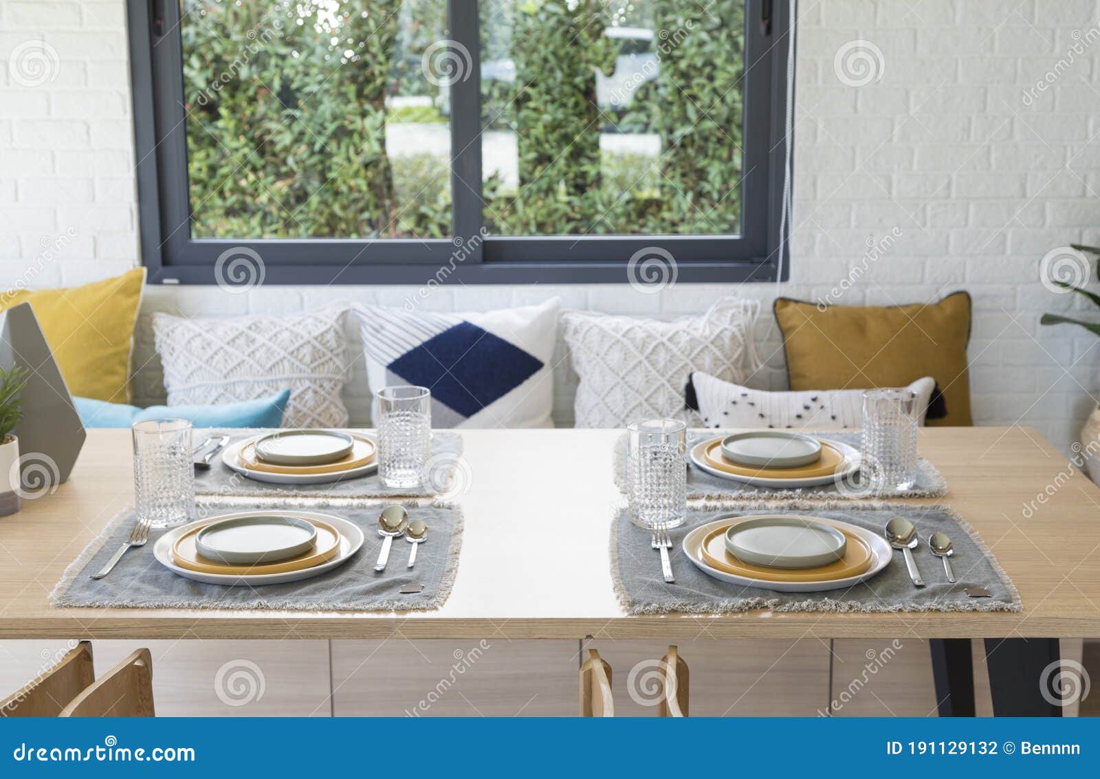 Table Set on Table with Yellow Plate Setting in Modern Style Dining ...