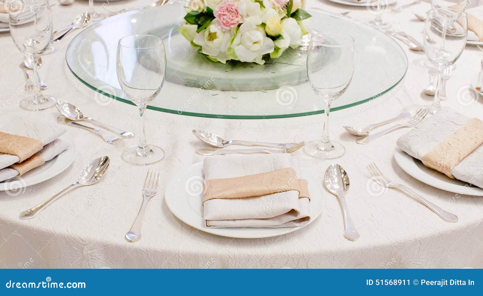 The Table is Set for a Western Style Dinner with Round Glass on Stock ...