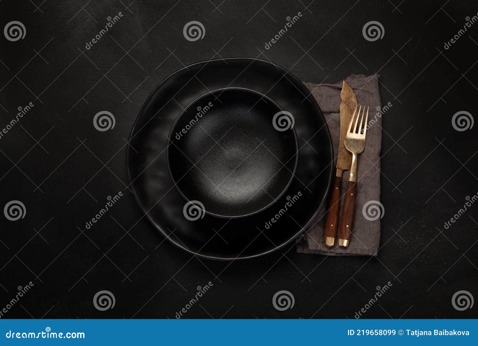 Table Setting with a Black Plates on a Black Background. Minimalism ...