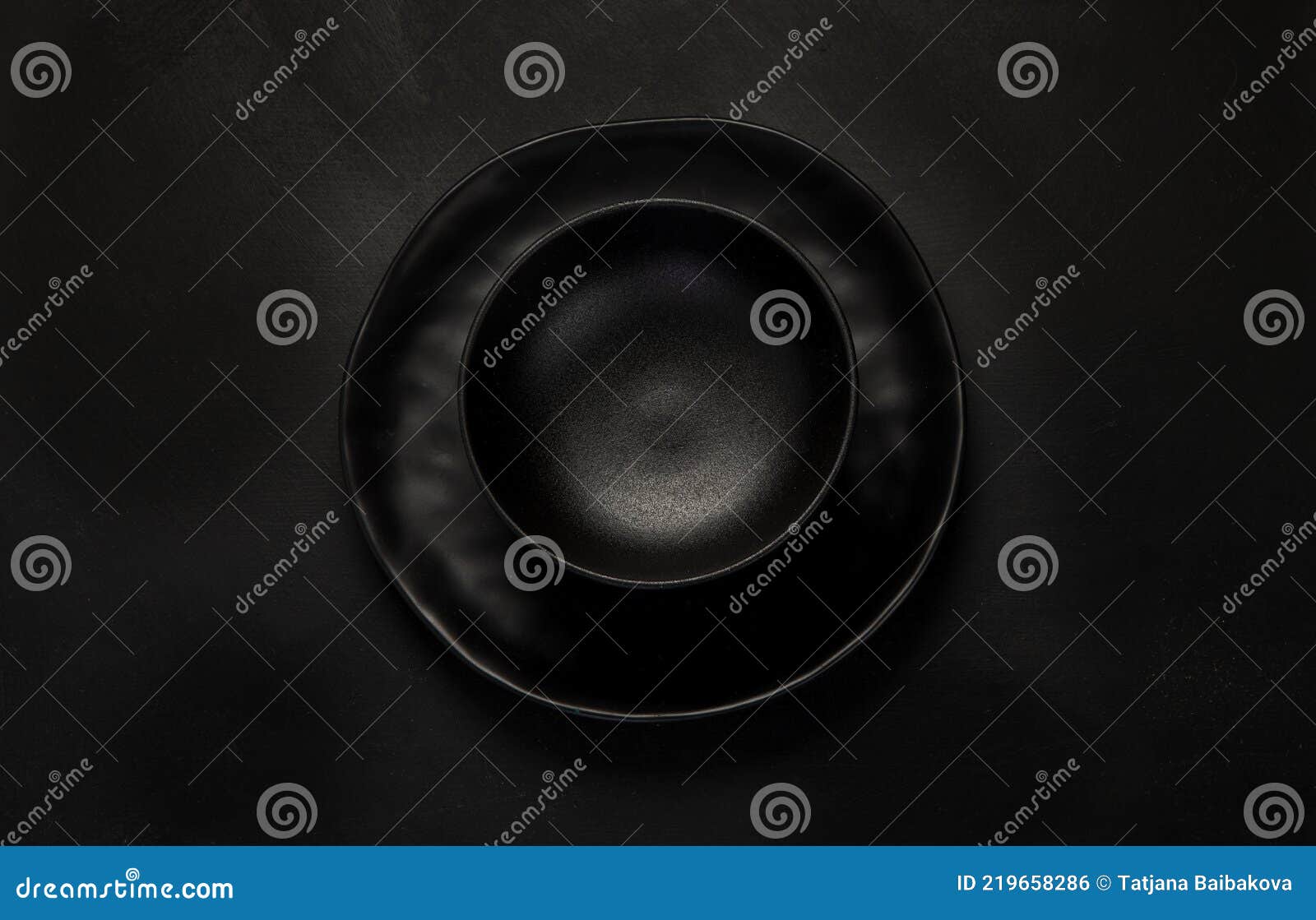 Table Setting with a Black Plates on a Black Background. Minimalism ...