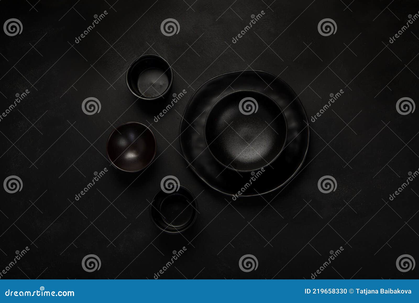Table Setting with a Black Plates on a Black Background. Minimalism ...