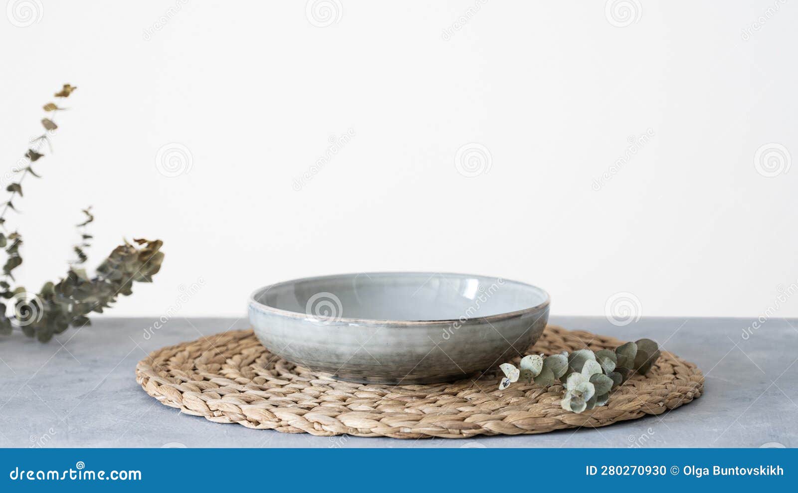 Table Setting with Ceramic Plate and Eucalyptus Branches on Blue ...