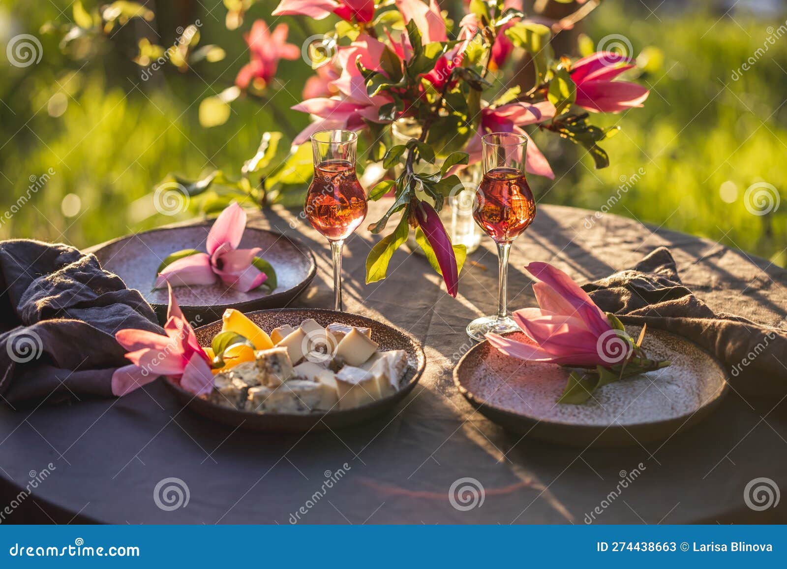 Table Setting in Garden on Sunset Light. Table Decorated with Magnolia ...