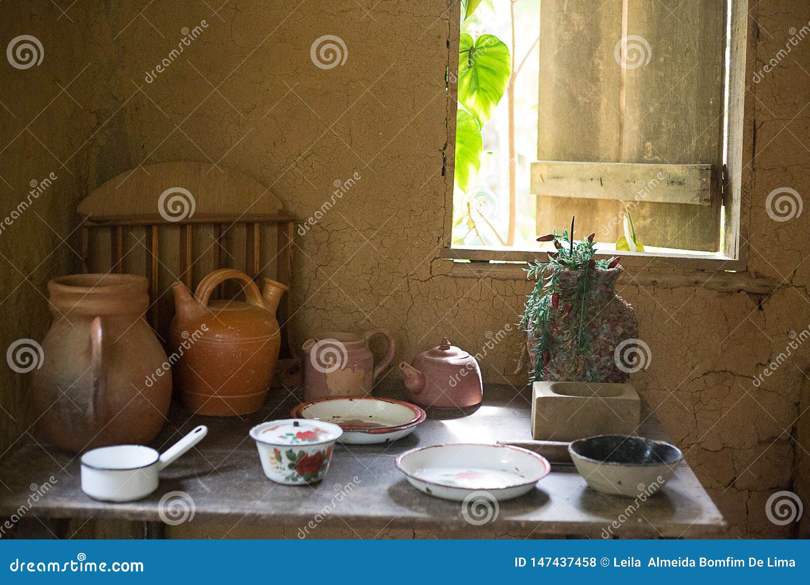 A Table with Several Decorated Old Objects. the Wall is Made of Clay is ...