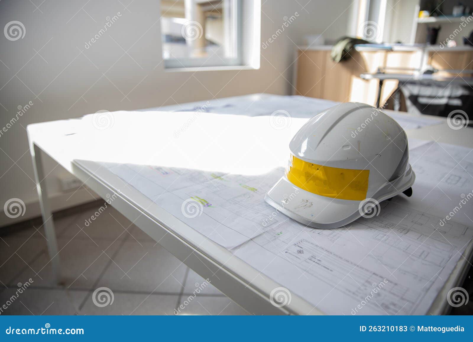 Table with a Technical Drawing and a Protective Helmet, Industrial ...