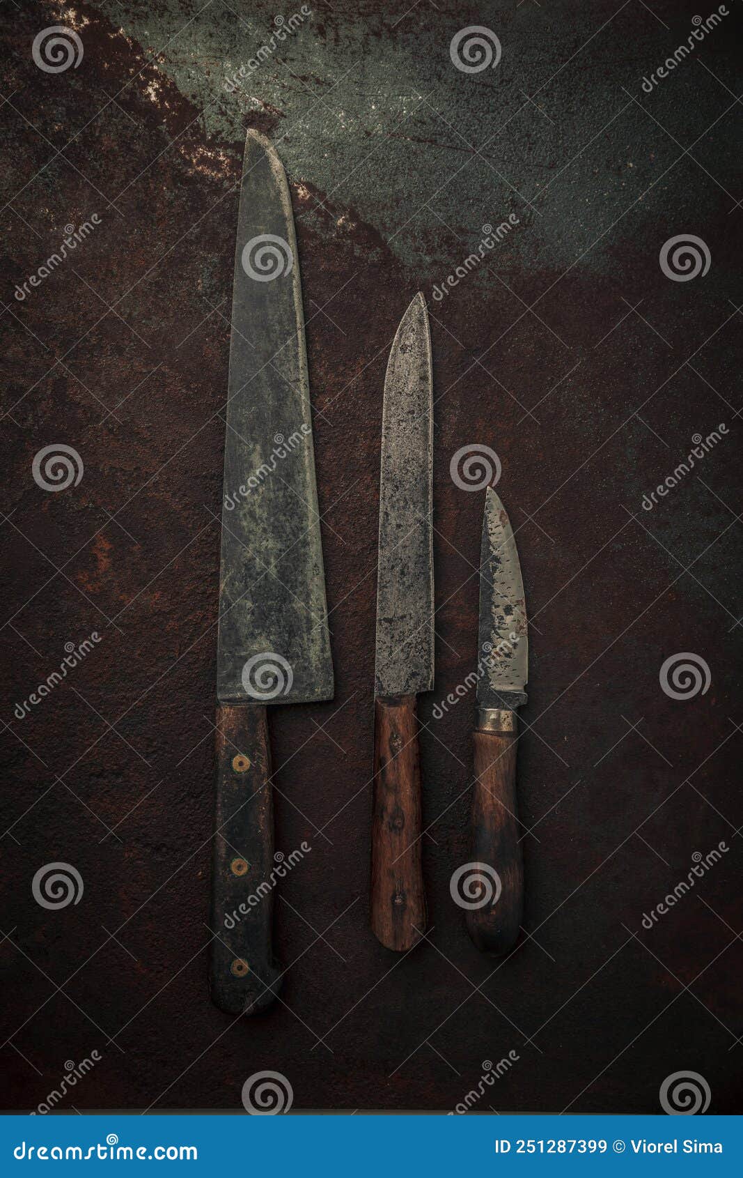 Table Top View of Three Rustic Knives on Old Rusty Metallic Background ...