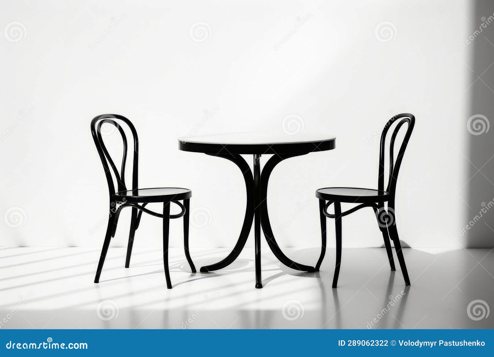 Table and Two Chairs Sitting Next To Each Other on White Floor ...