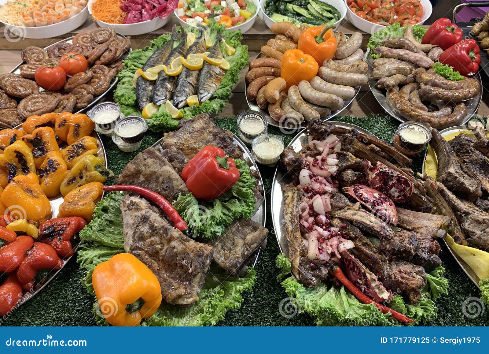Table with a Variety of Meat and Fish Dishes, Appetizers and Salads ...