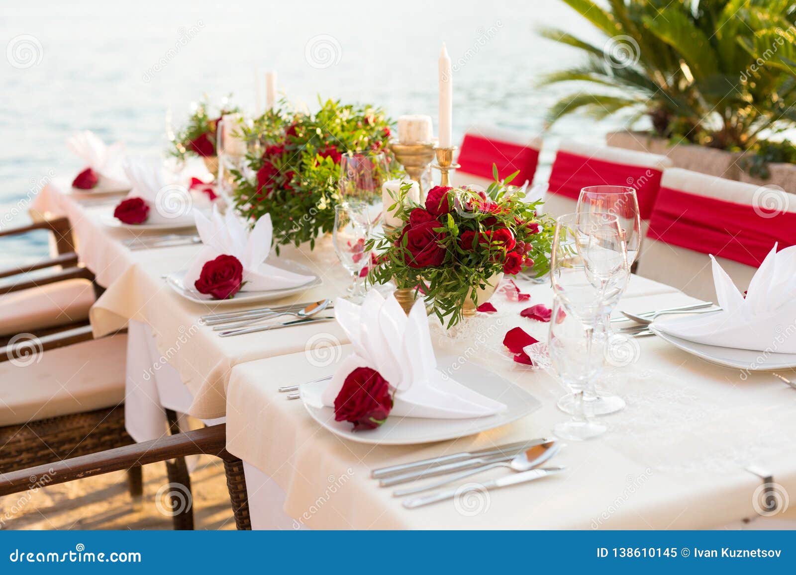 Table for a Wedding Dinner Decorated with Red Flowers and Greenery ...