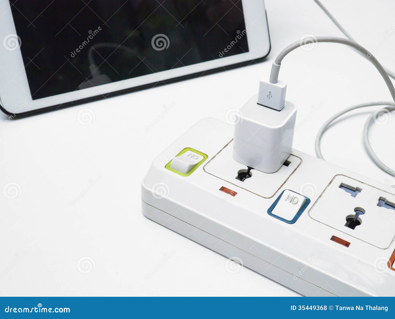 Tablet , Battery Charger and Bloc Multiprise 3 Prises Stock Photo ...