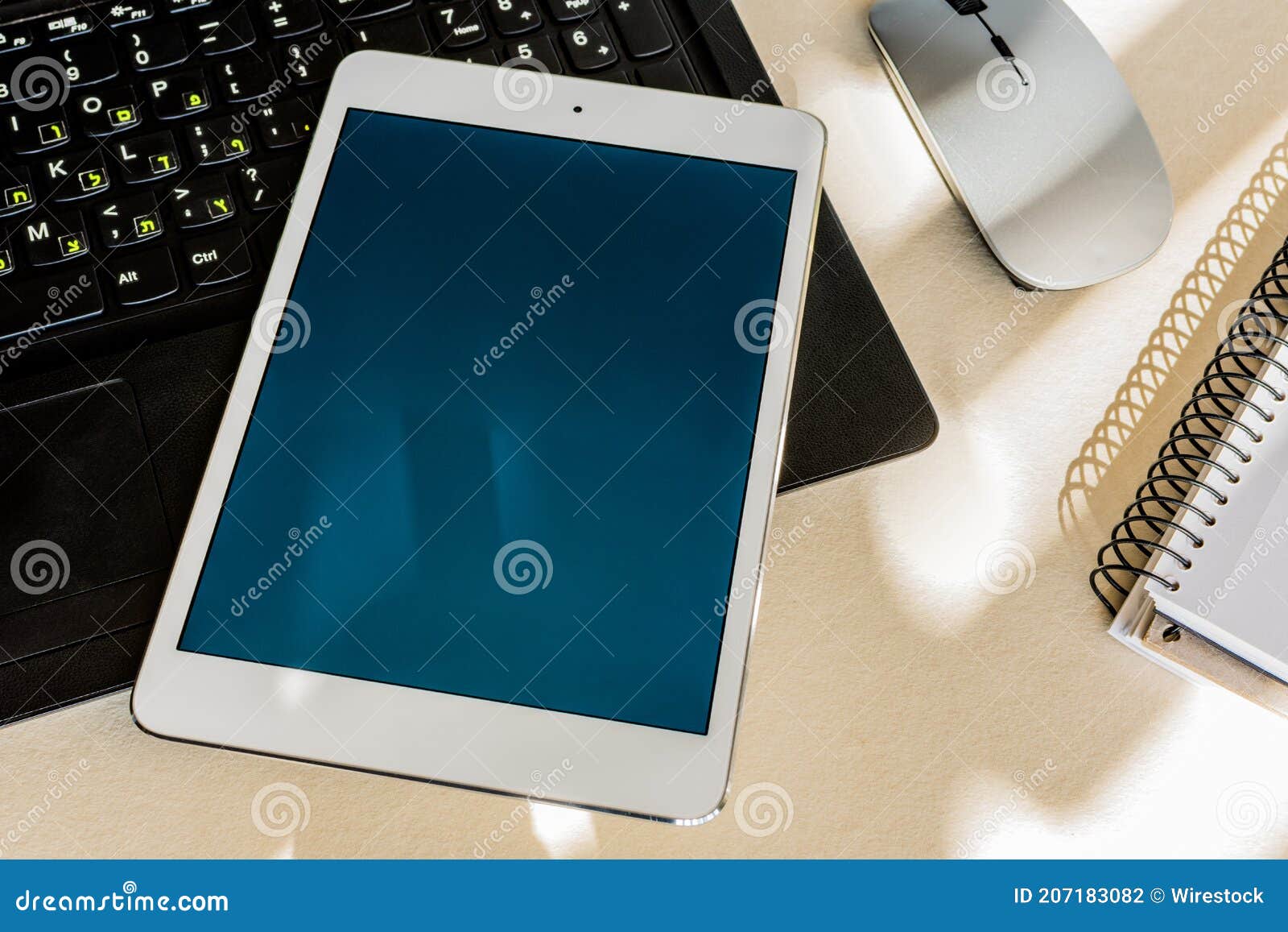Tablet with Blue Screen on the Keyboard of a Laptop on a Desk ...