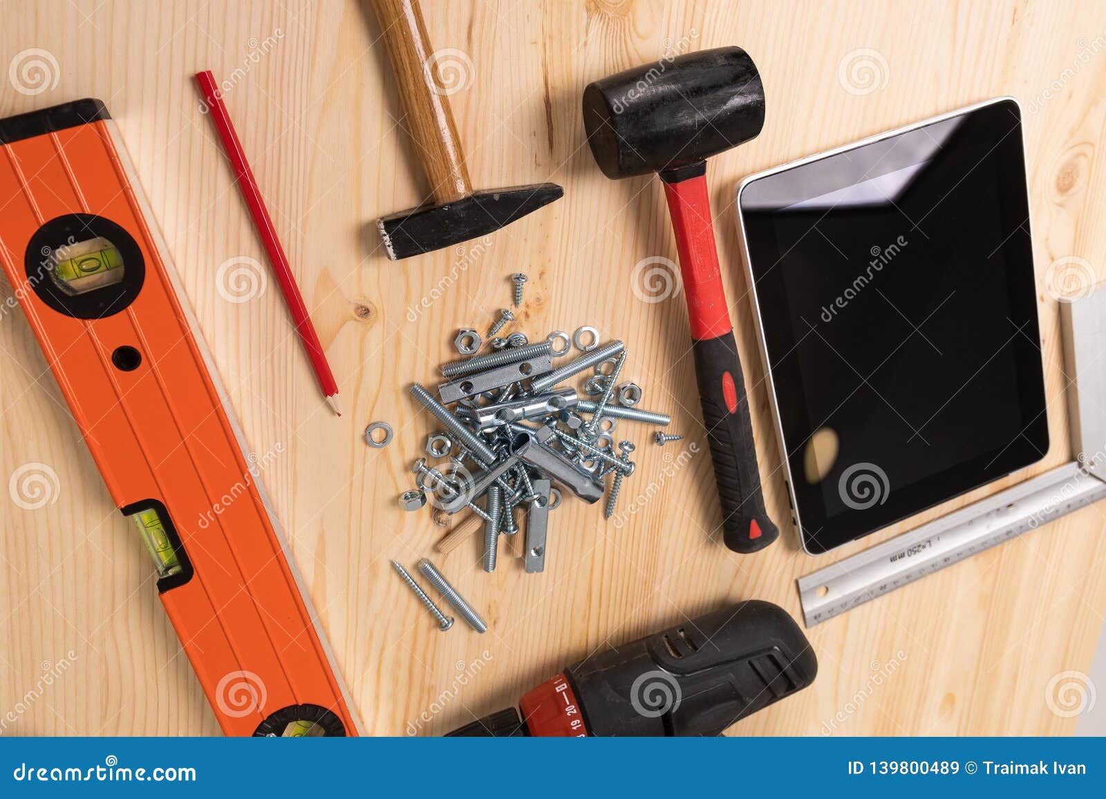 Construction Tool and a Digital Tablet Lie on a Light Wooden Table ...