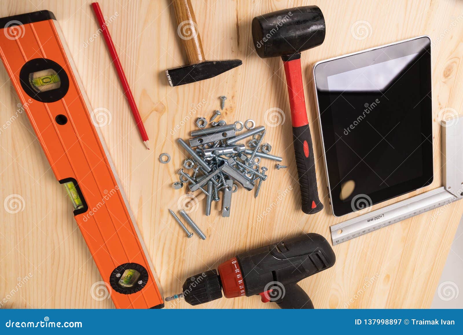 Construction Tool and a Digital Tablet Lie on a Light Wooden Table ...