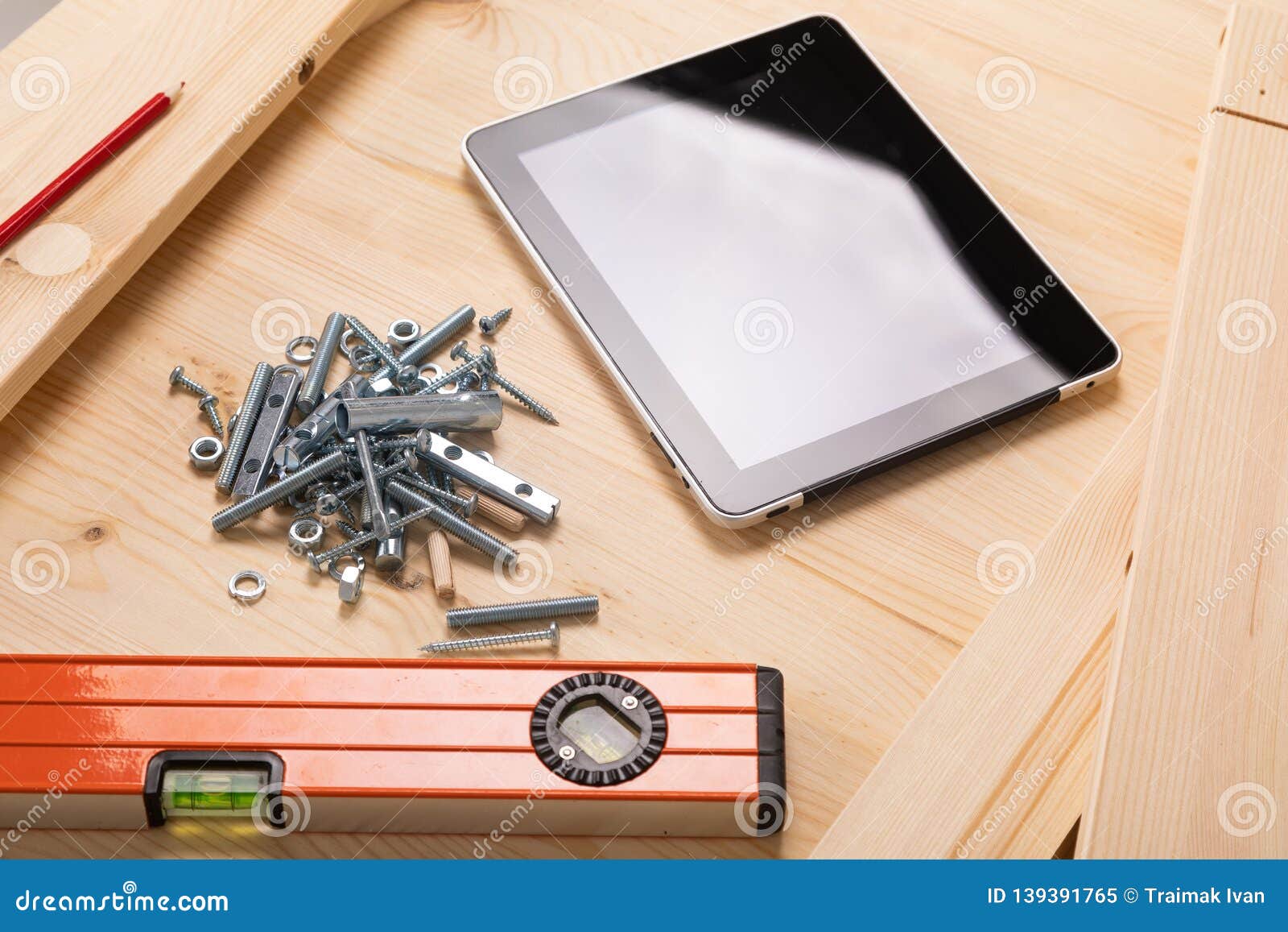 Construction Tool and a Digital Tablet Lie on a Light Wooden Table ...
