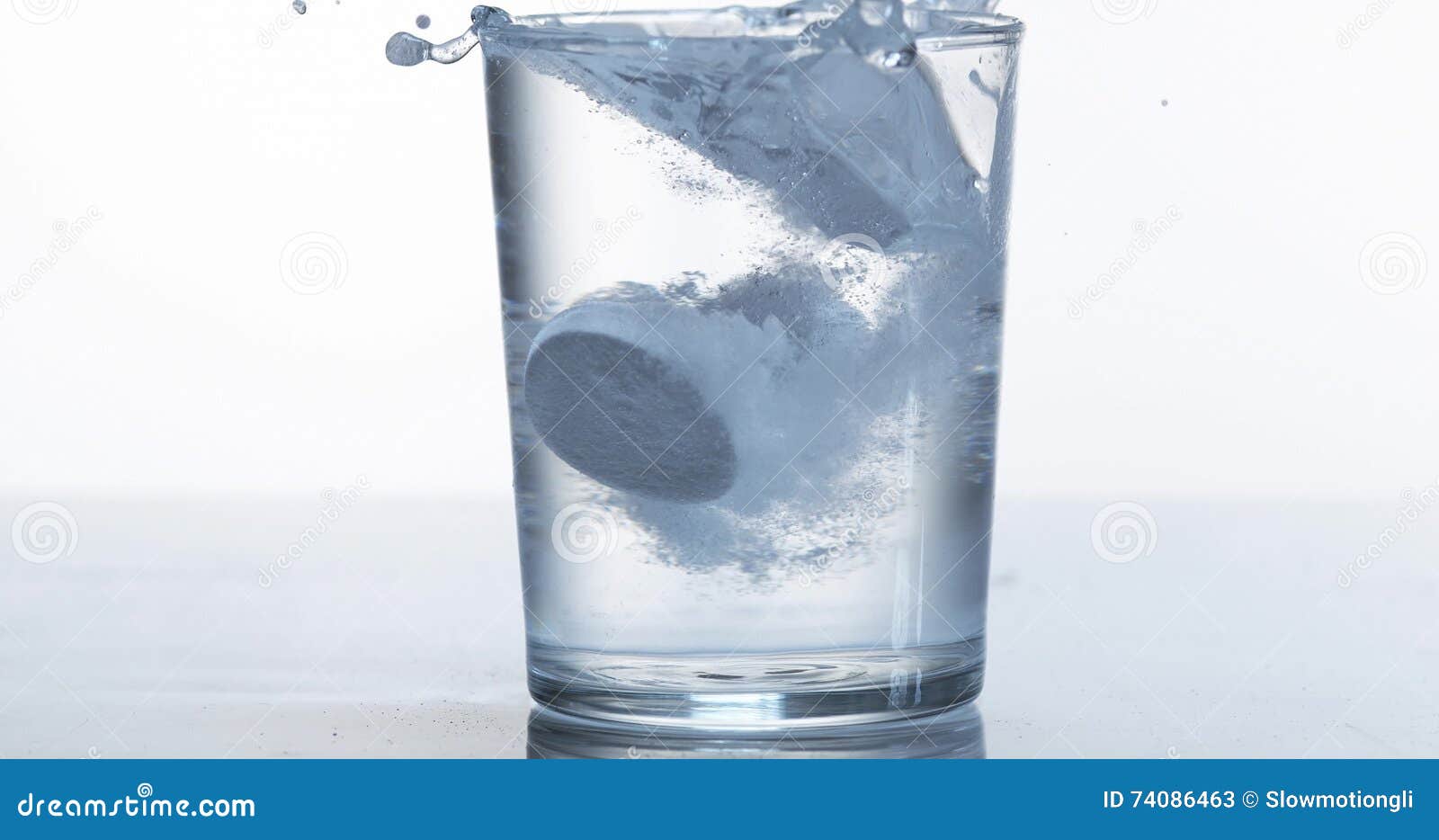 Tablet Falling and Dissolving into a Glass of Water Against White ...