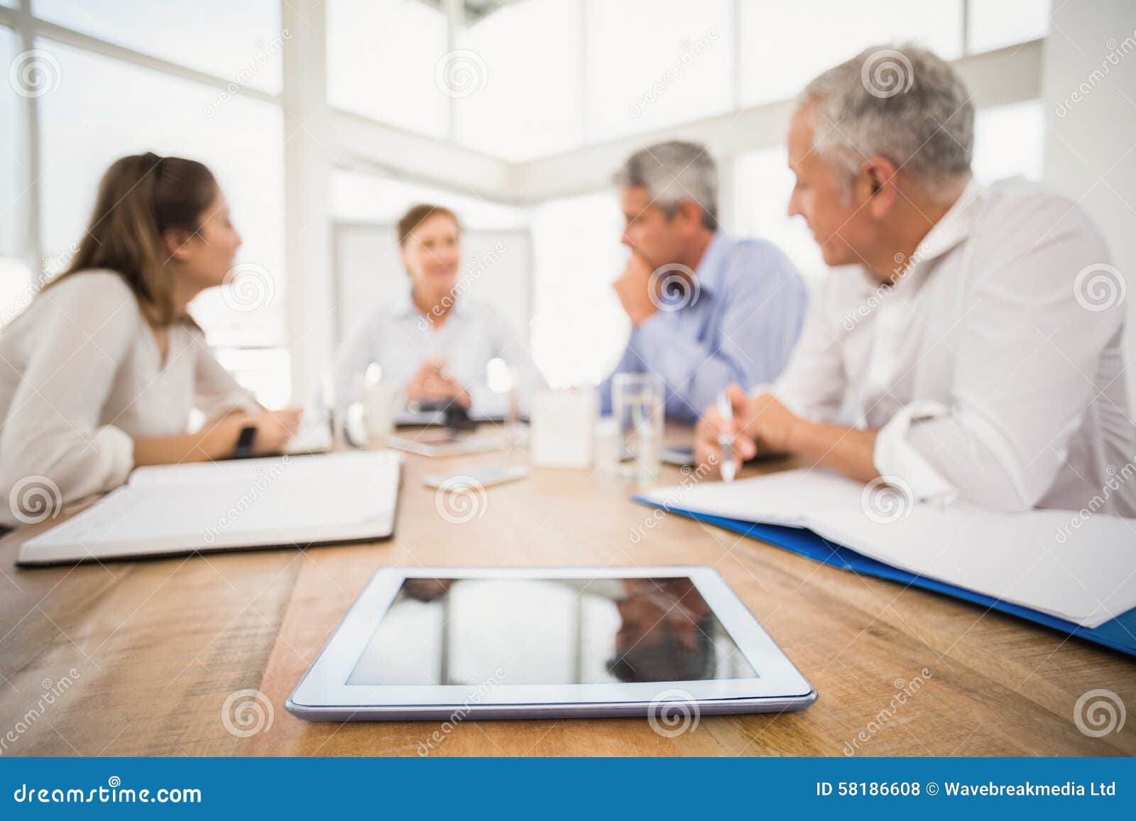 Tablet in Front of Talking Business People Stock Photo - Image of ...