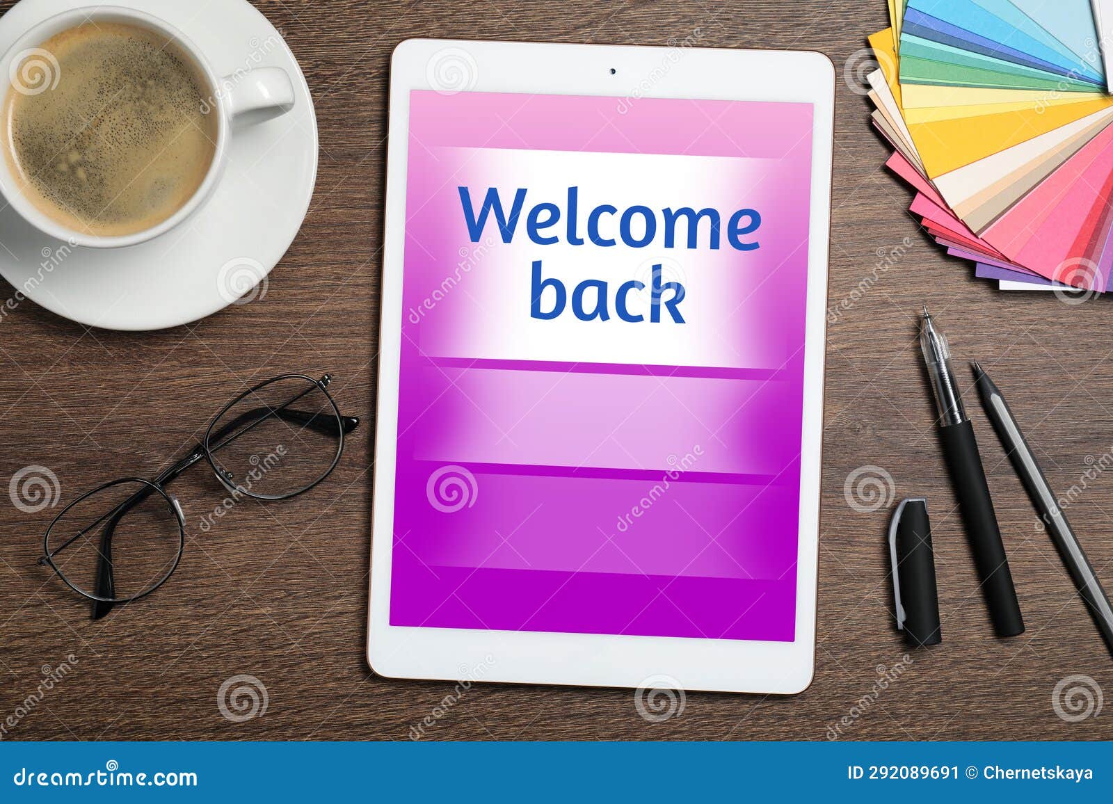 Tablet with Phrase Welcome Back on Wooden Table. Office Desk with Cup ...