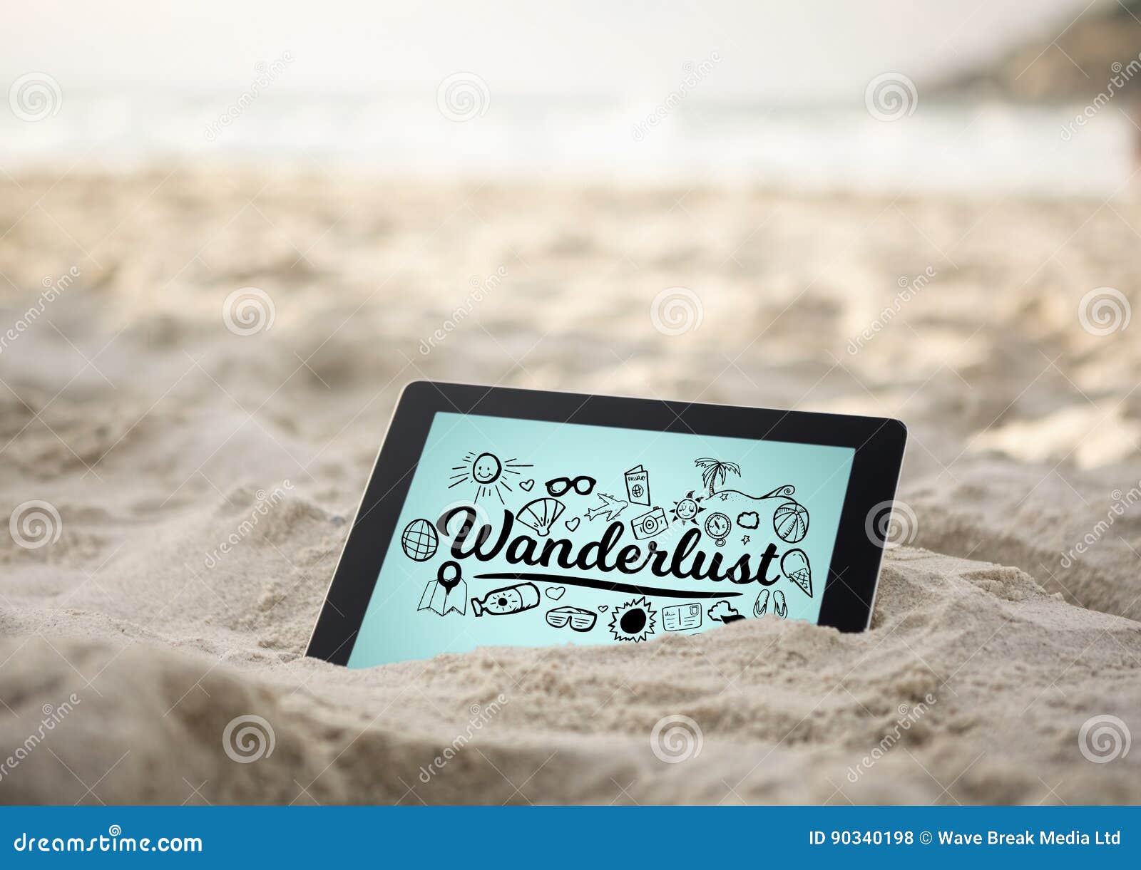 Tablet in Sand with Black Wanderlust Doodles Against Blue Background ...