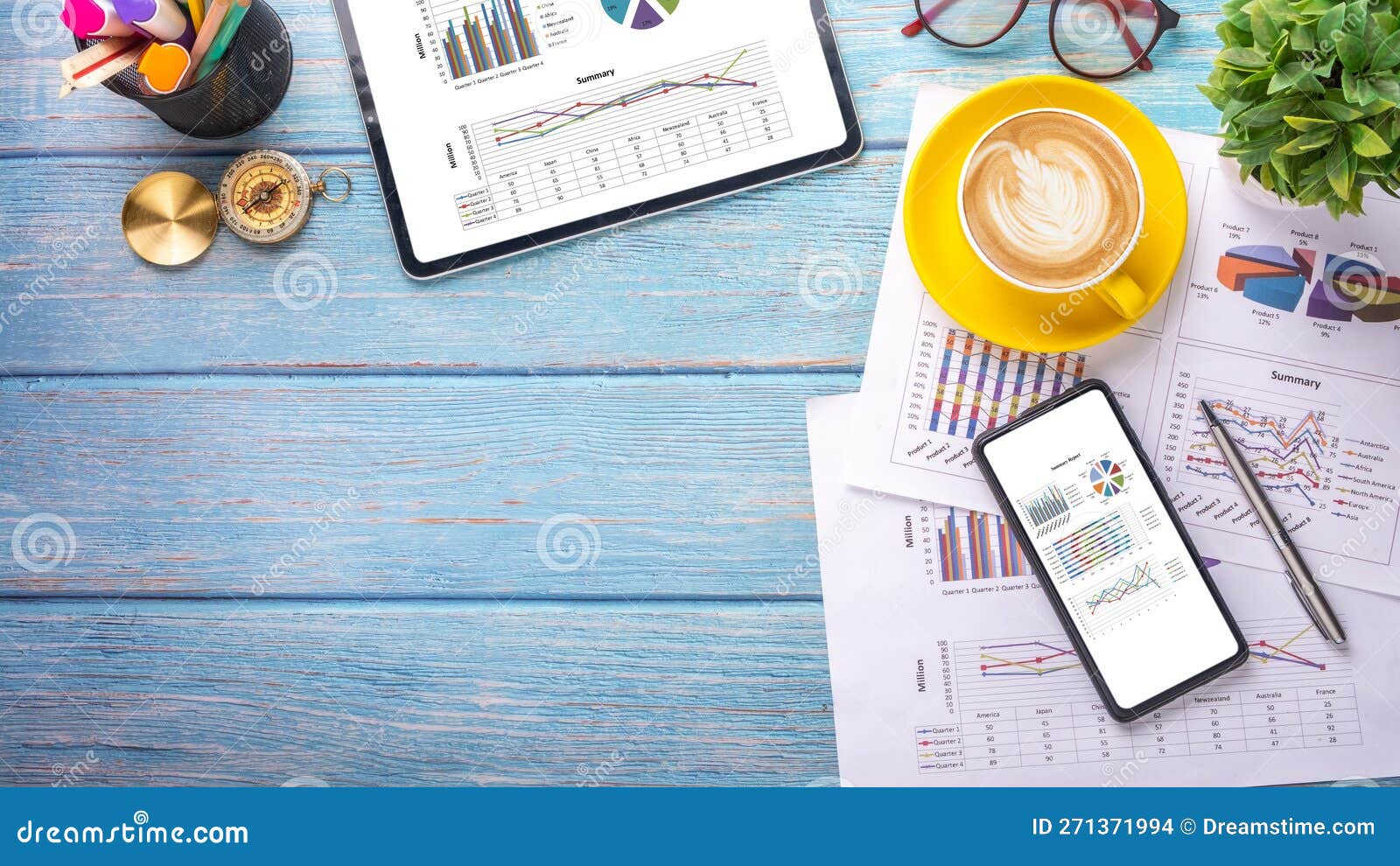 Tablet and Smart Phone with Charts and Reports on Office Desk Workplace ...