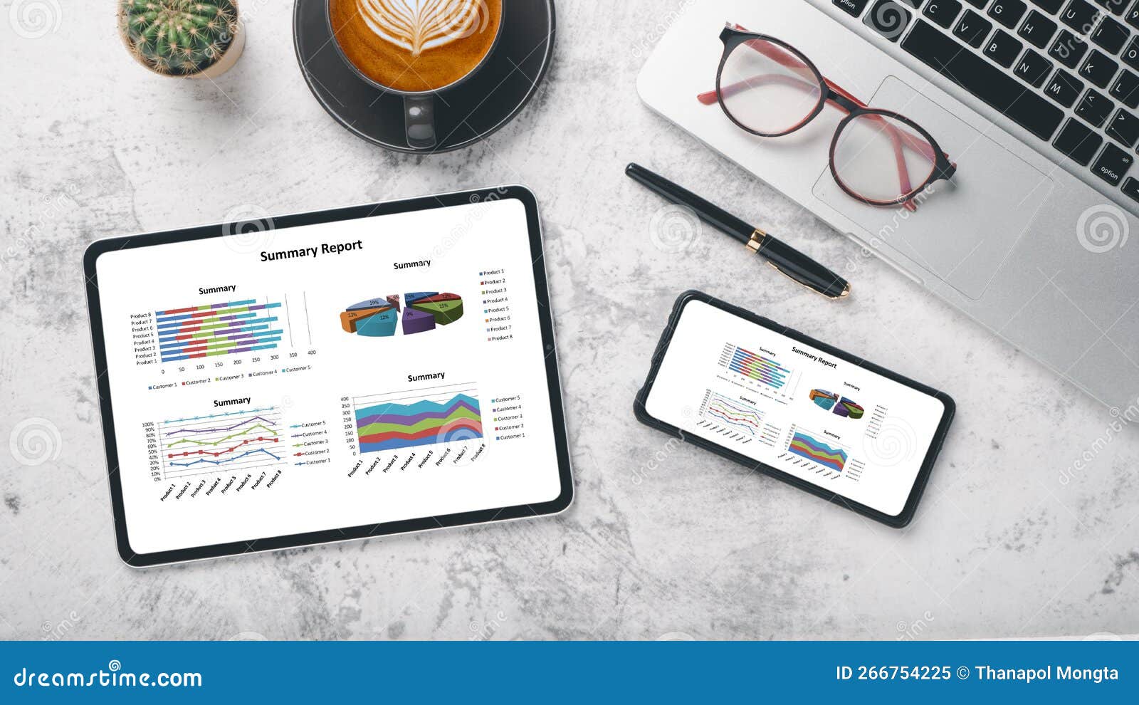 Tablet and Smartphone with Charts and Reports on Office Desk Workplace ...