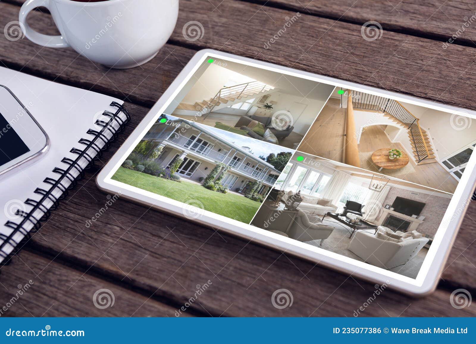 Tablet with View of Home from Security Cameras on Screen Lying on ...