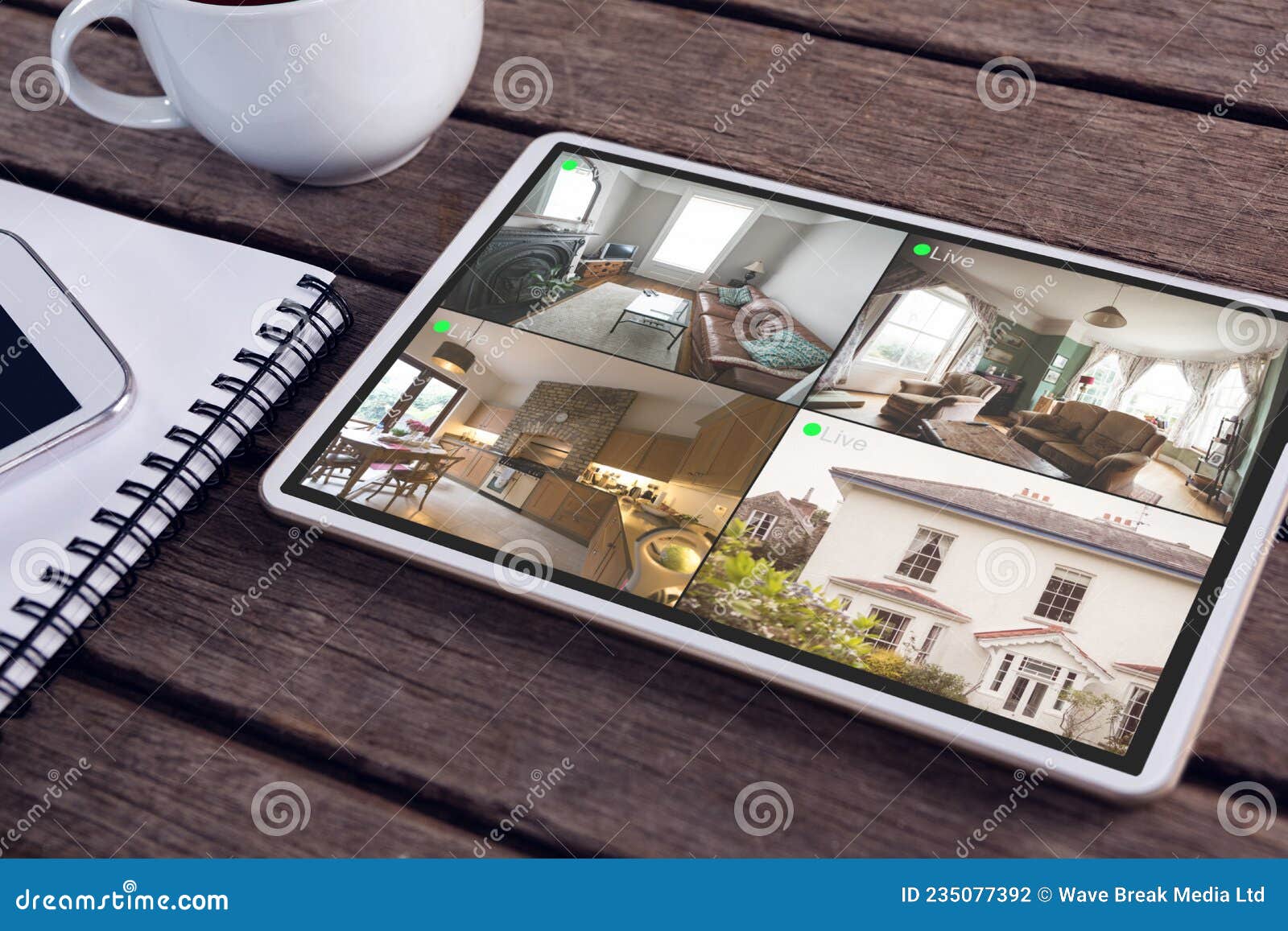 Tablet with View of Home from Security Cameras on Screen Lying on ...
