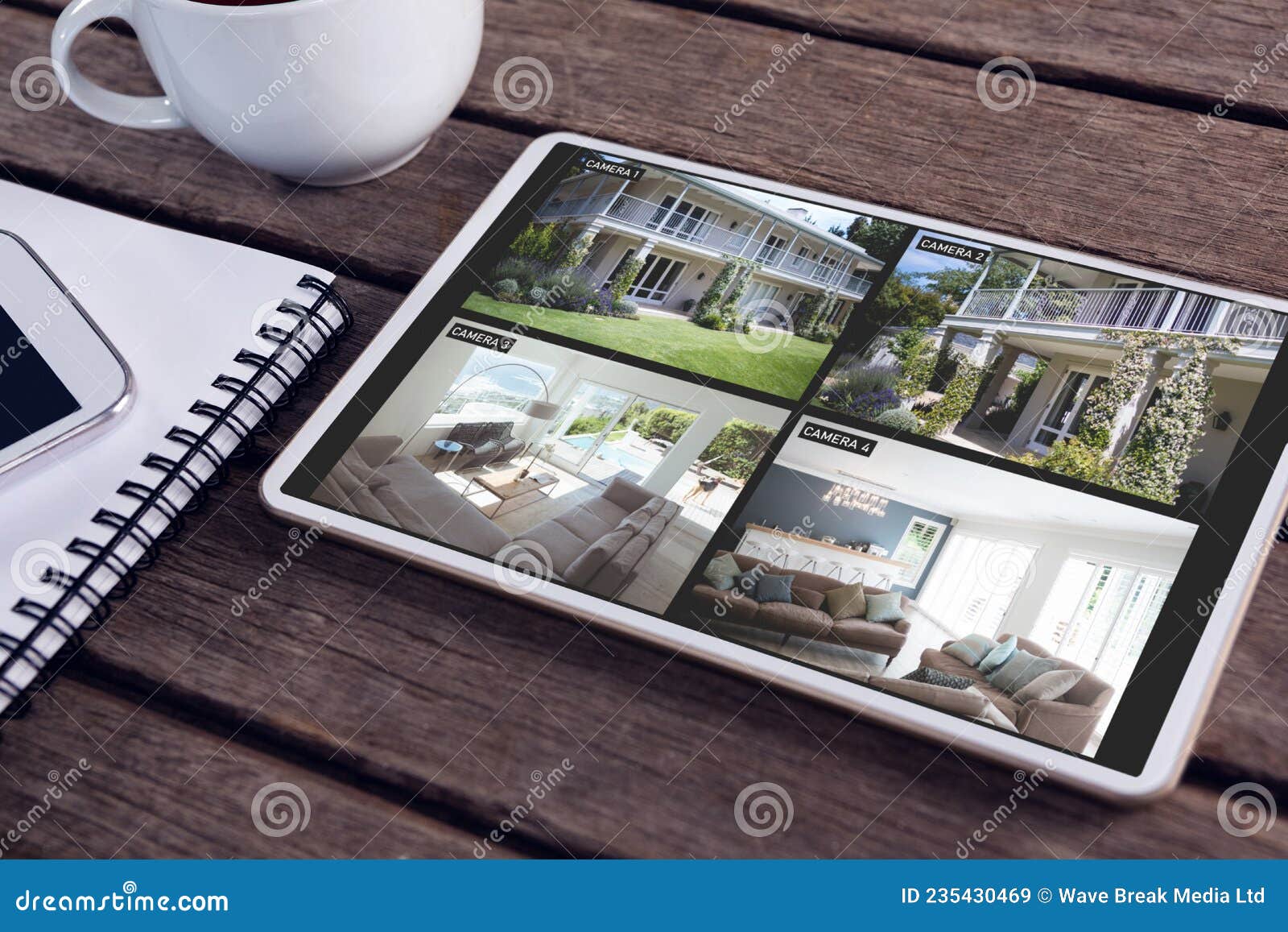 Tablet with Views of Home from Security Cameras on Screen Lying on ...