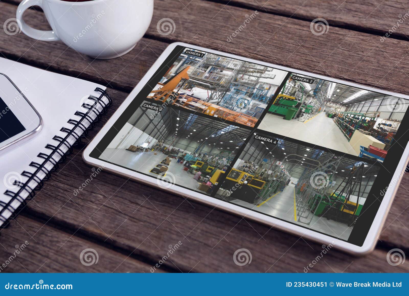 Tablet with Views of Warehouse from Security Cameras on Screen Lying on ...
