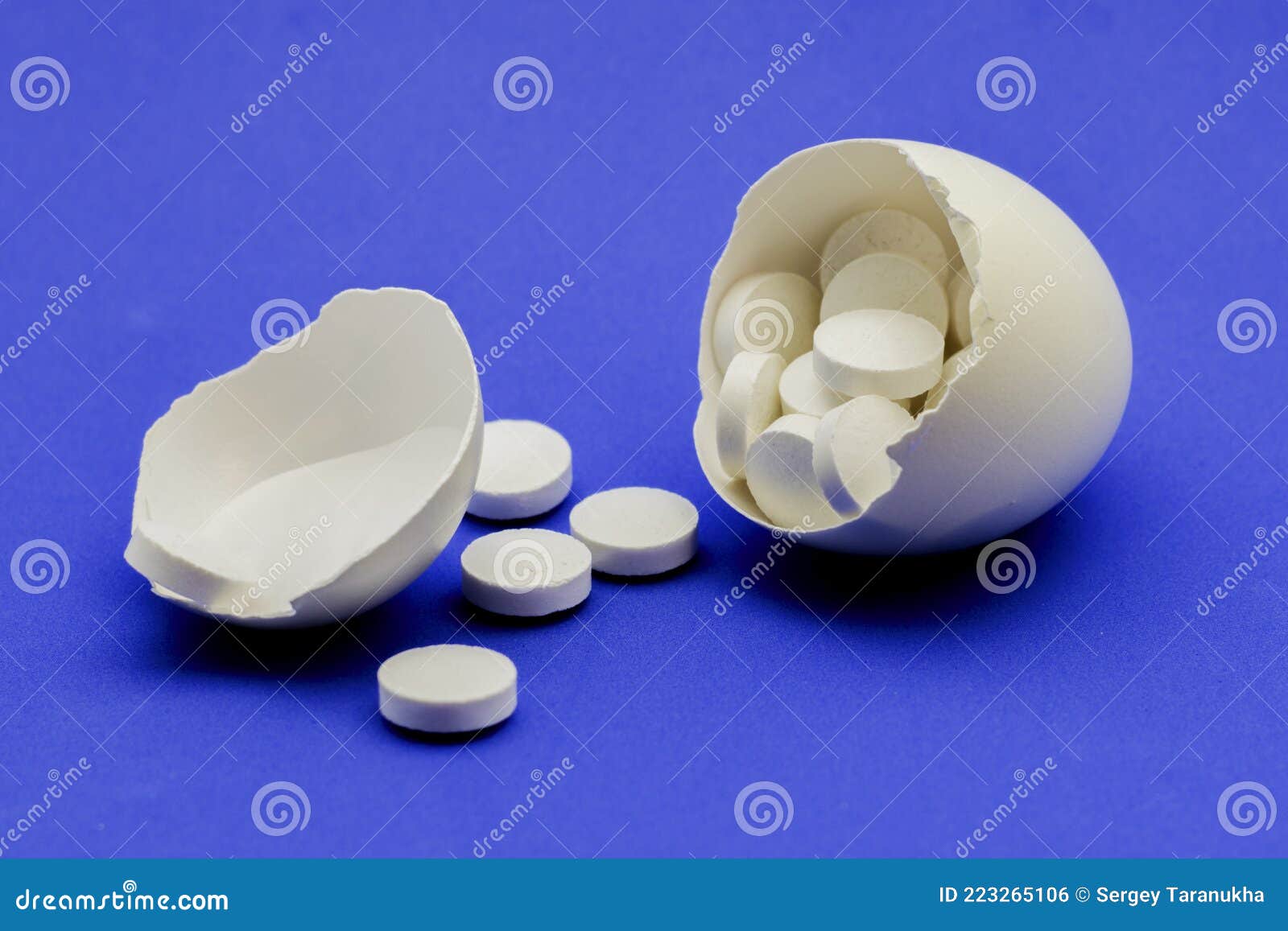 Tablets in a Broken Chicken Egg on a Blue Background Concept Medicine ...