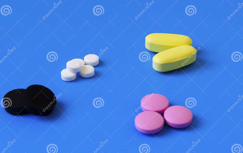 Tablets of Different Colors on a Blue Background Stock Image - Image of ...