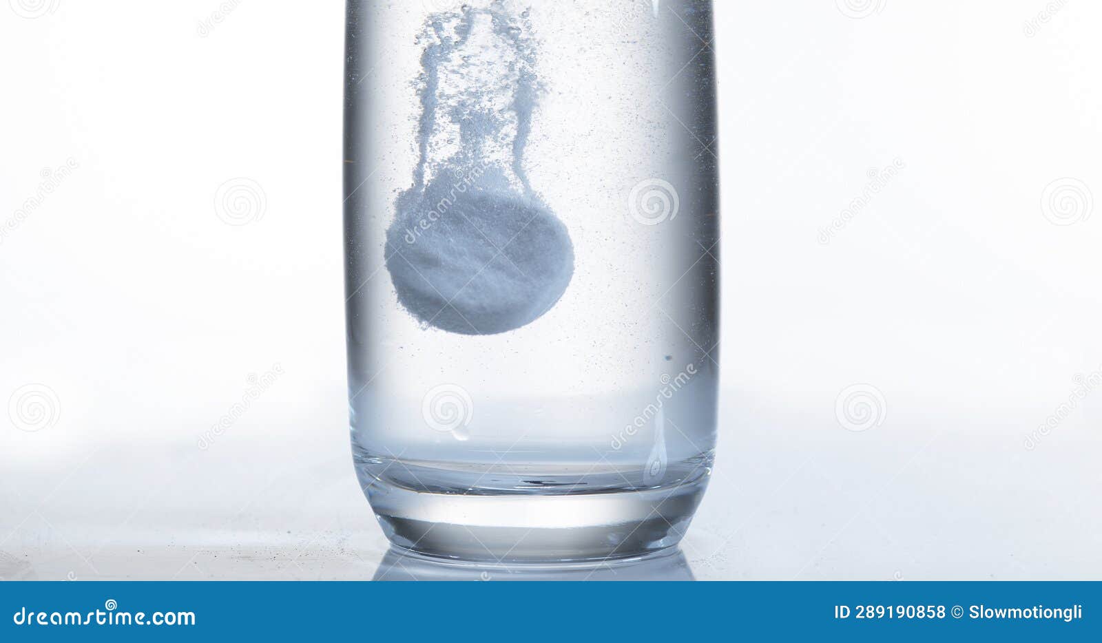 Tablets Falling and Dissolving into a Glass of Water Against White ...