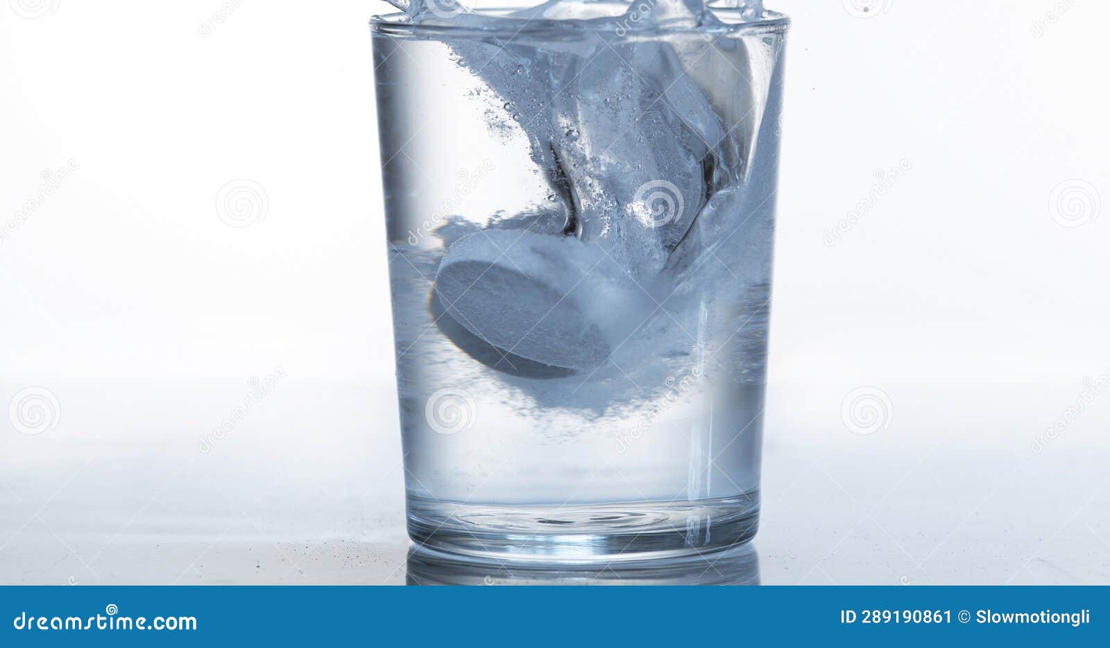 Tablets Falling and Dissolving into a Glass of Water Against White ...