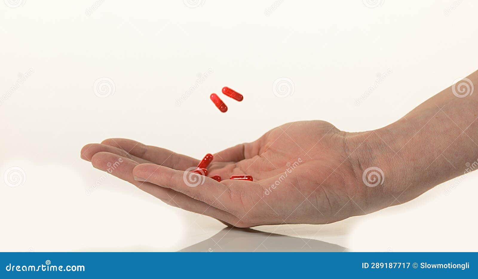 Tablets Falling into Hand Against White Background Stock Image - Image ...