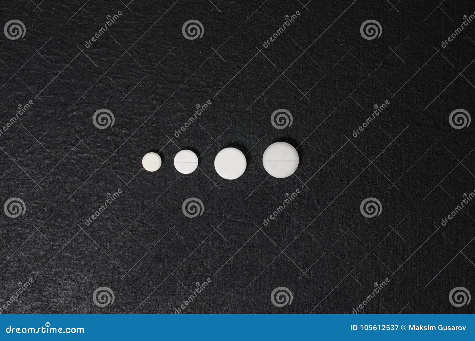 Tablets Lined In Rows On A Black Background, Different Size, Close Up ...