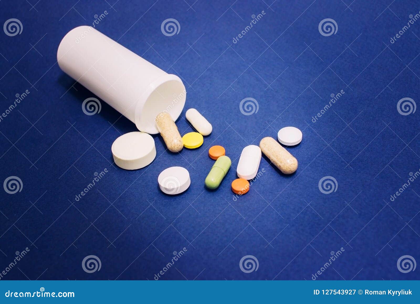 Tablets from a Vial on a Blue Background Stock Image - Image of ...