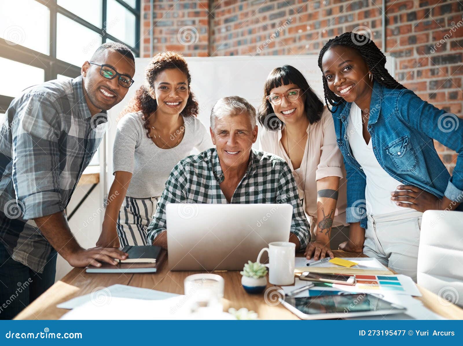 We Tackle Our Tasks As a Team. a Group of Colleagues Using a Laptop ...