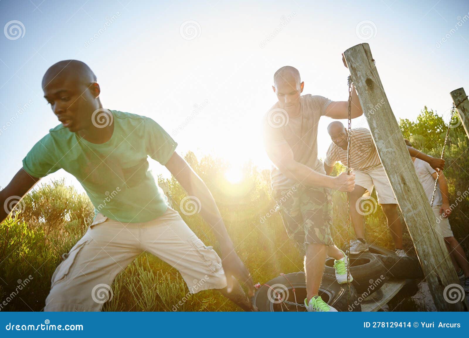 Tackling the Obstacle Course with Determination. a Group of Young Men ...