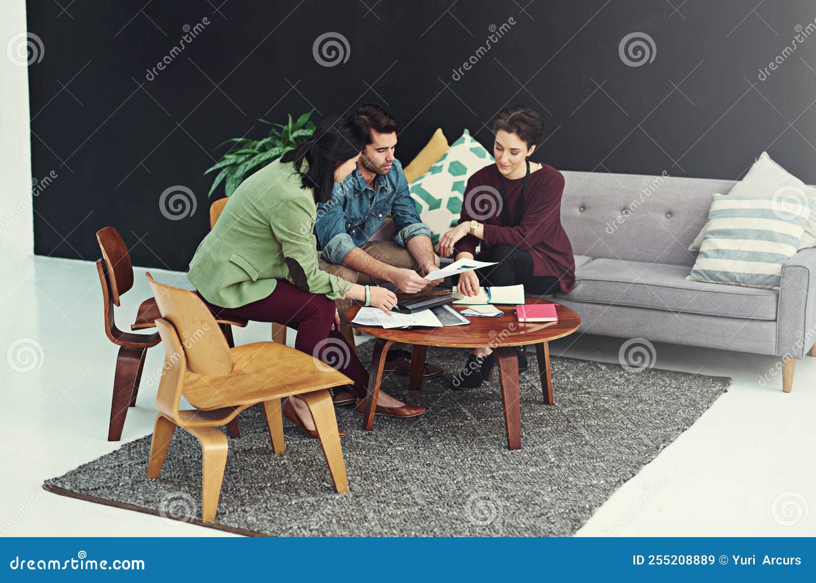 Tackling the Task at Hand. a Group of Young Creatives Having a Meeting ...