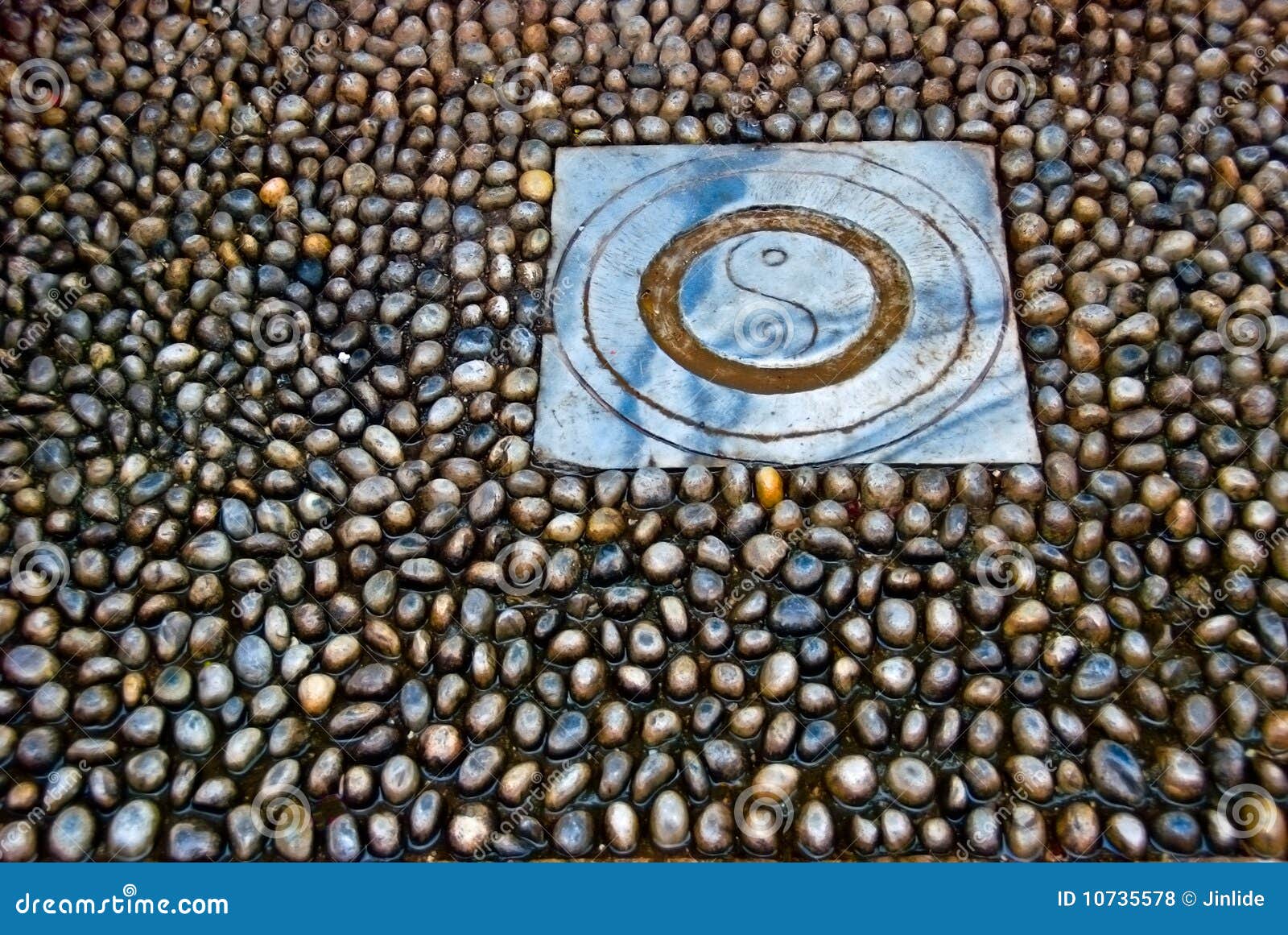 A Taiji Symbol Utility Cover on Pebble Background Stock Photo - Image ...