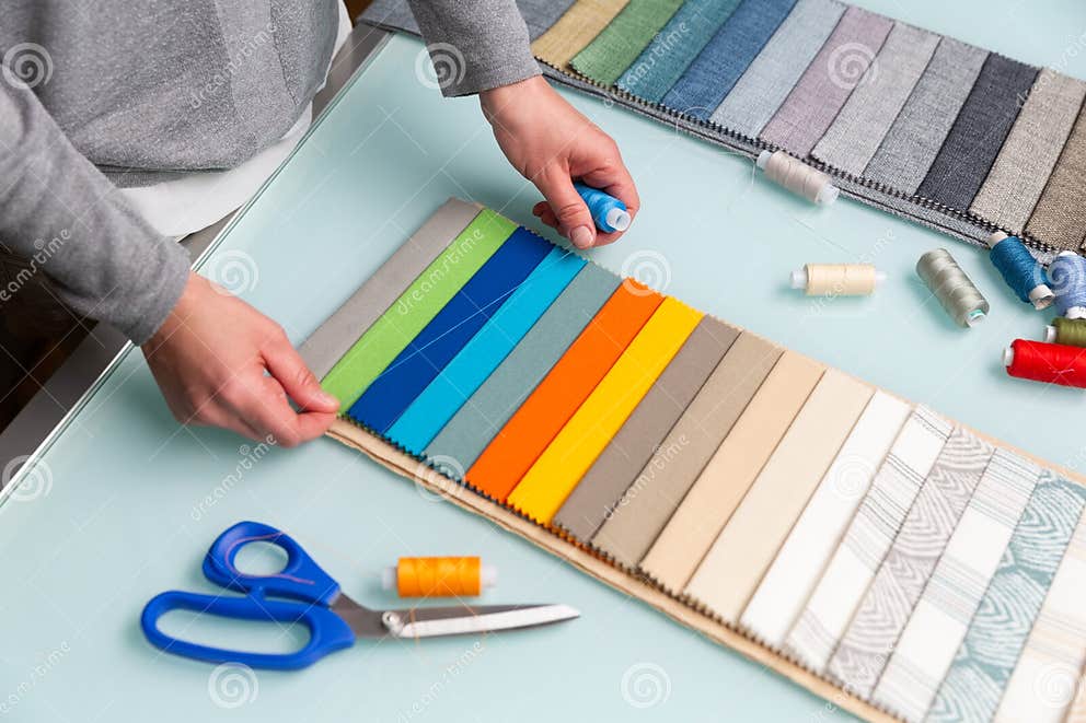 Tailor Choosing Right Color of a Blue Thread Using Fabric Samples on ...