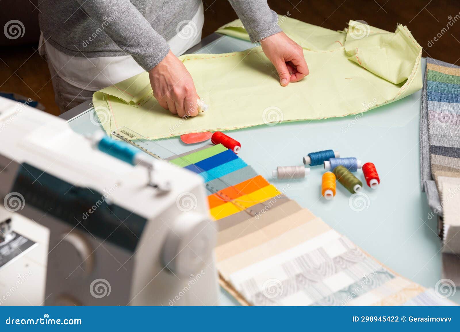 Tailor Choosing Right Color of a Thread Using Fabric Samples on Table ...