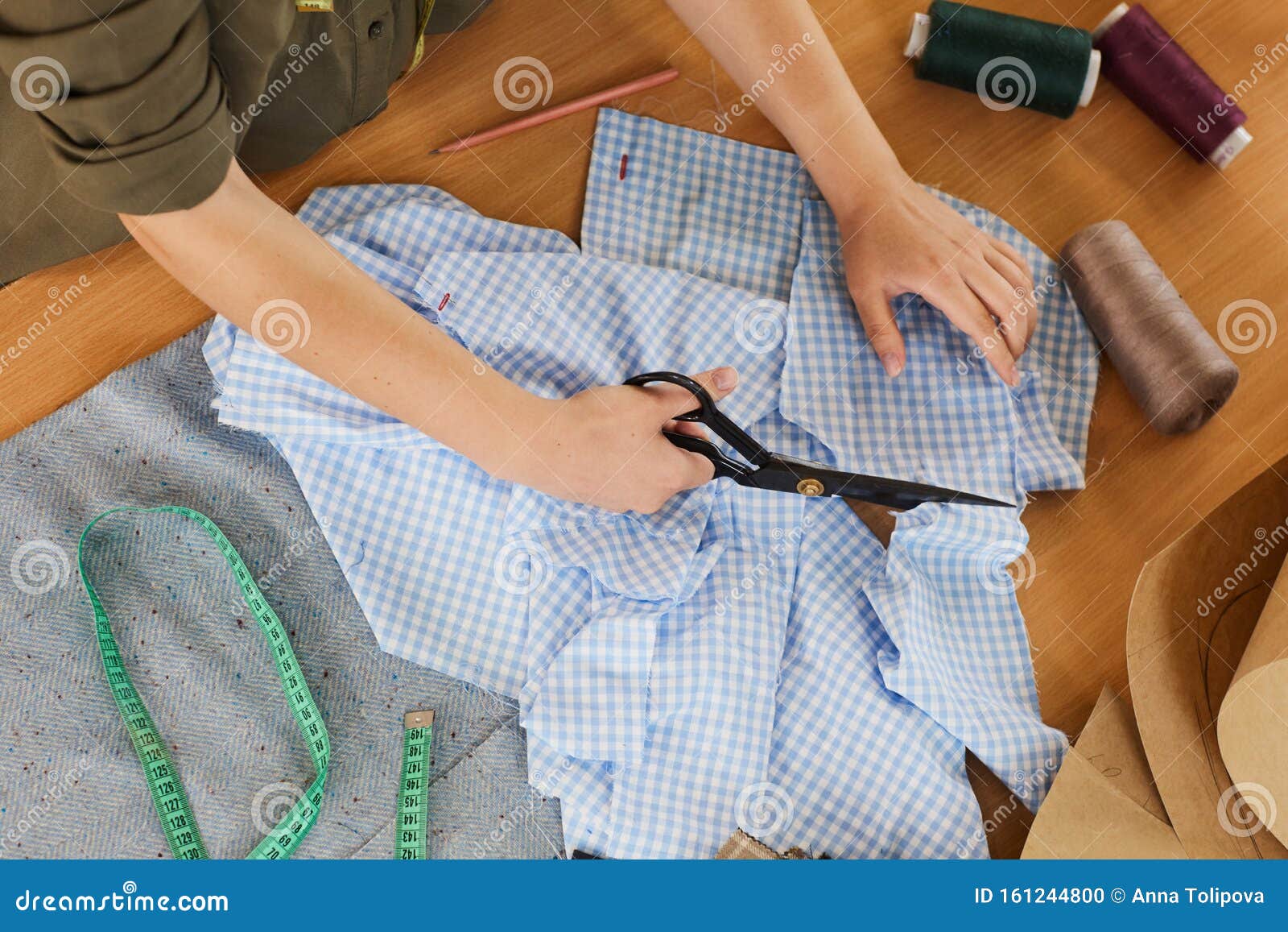 Tailor cutting fabric stock photo. Image of scissors - 161244800