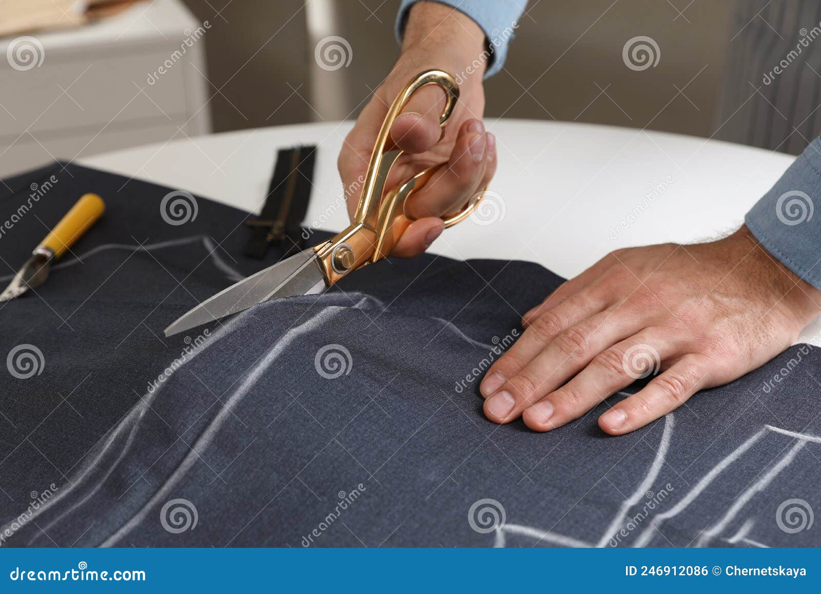 Tailor Cutting Fabric with Scissors at Table in Atelier, Closeup Stock ...