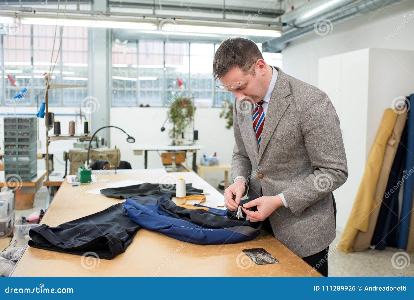 Tailor Hand Sewing the Lining in a Blue Jacket Stock Photo - Image of ...
