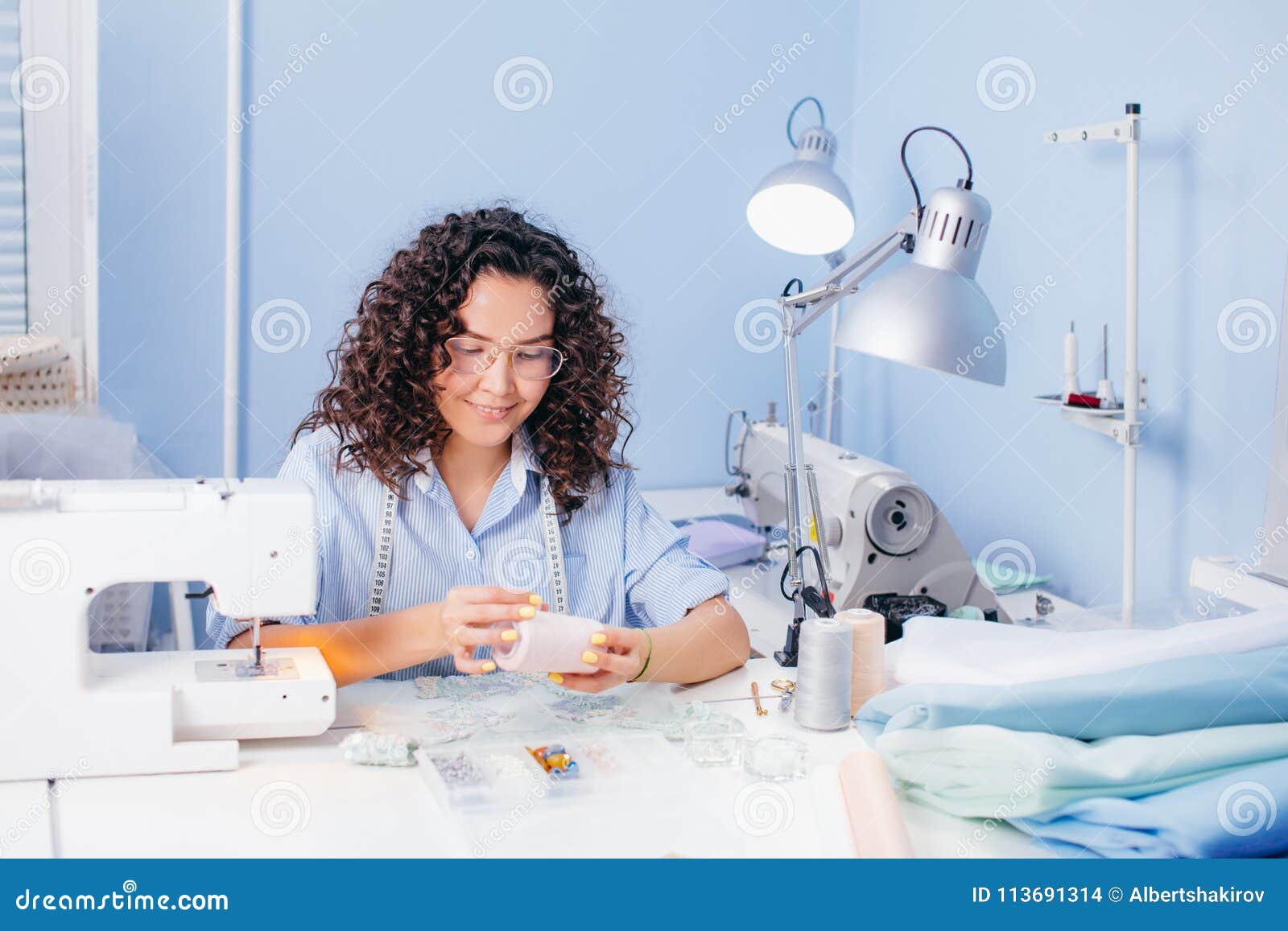 Tailor Having Bobbin with Thread on Hands Sitting at the Table Indoors ...