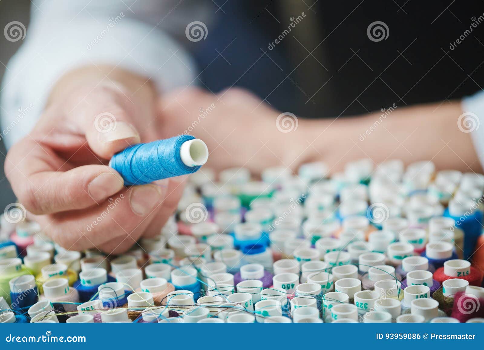 Tailor Holding Sewing Spool in Atelier Stock Photo - Image of textile ...